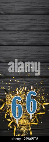 Number 66 blue celebration candle on white wooden background. Happy ...