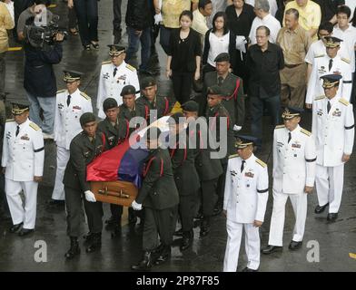 Filipino soldiers carry the casket of the late Philippine President ...