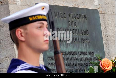 An honor guard stands beside a plaque commemorating the execution of ...