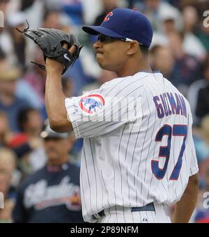 Chicago Cubs pitcher Angel Guzman looks to first base after Detroit ...