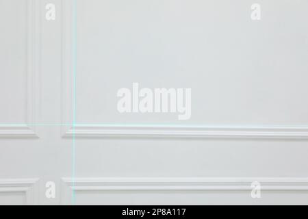 Cross lines of laser level on white wall Stock Photo - Alamy