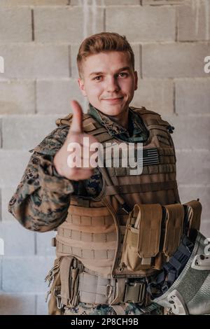 The soldier makes a gesture of success with his hand. A soldier in full ...