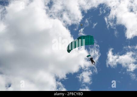 view of parachute descending with two people Stock Photo - Alamy