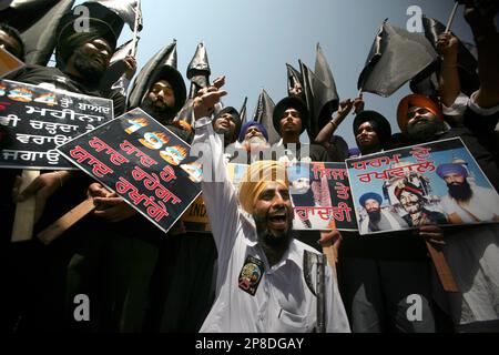 Indian Sikhs hold placards as they shout slogans during a protest to ...
