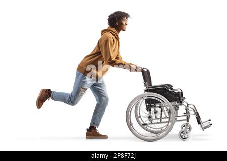 Man running and pushing an african american guy inside a shopping cart ...