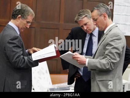 Defense attorney Timothy Bradl, left, talks to Christian Karl ...
