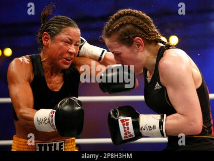 Boxer Ina Menzer of Germany, right, punches challenger Franchesca ...