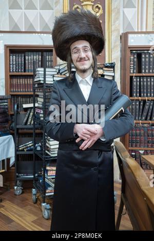 Posed portrait of a hasidic man wearing a shtreimel fur hat in an empty ...