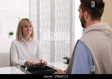 Man receiving money at cash department window in bank. Currency ...
