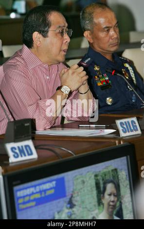 Philippine Interior and Local Government Secretary Ronaldo Puno uses a ...
