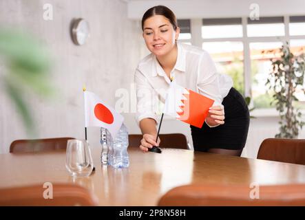 Female secretary places flags of Bahrain and European Union flag on the ...