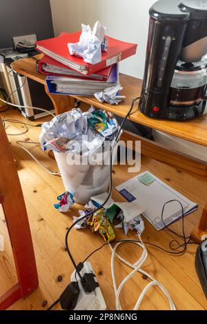 Messy office workplace. Cluttered untidy space. Open cartons and papers ...