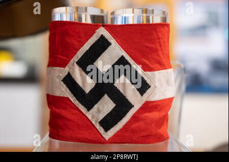 A small piece of fabric with the Nazi flag on it isolated on a white ...