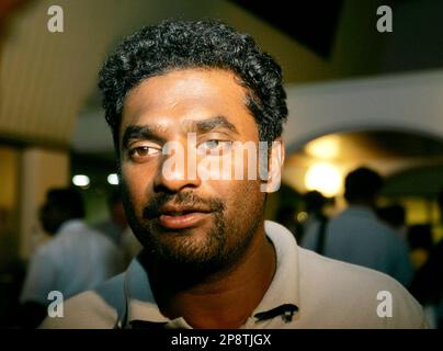 Sri Lankan cricketer Muttaiah Muralitharan, right, talks to his wife ...