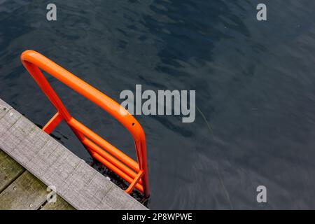 Selective focus at orange dock ladder and wooden floor over water Stock ...