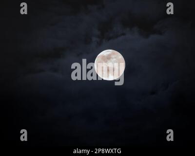 Full moon with large amounts of fast moving cloud cover near Spring ...