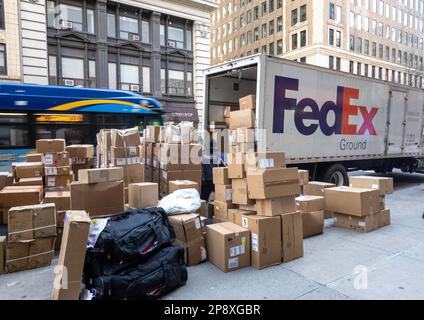 Stacks of boxes, ready for delivery by FedEx on fifth Avenue in midtown ...