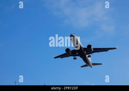 Commercial aircraft overflying the sky and arriving at airport Stock ...