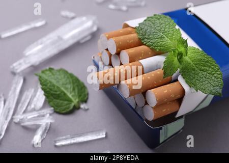 Many cigarettes on grey background Stock Photo - Alamy