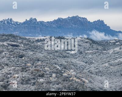 Aerial view of snow-capped Montserrat and Matadepera village after the ...