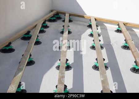Constructing terrace wooden area on plastic piles adjustable level stud ...