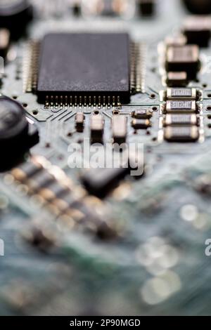 closeup of a circuit board from a hard drive with transistors and ...