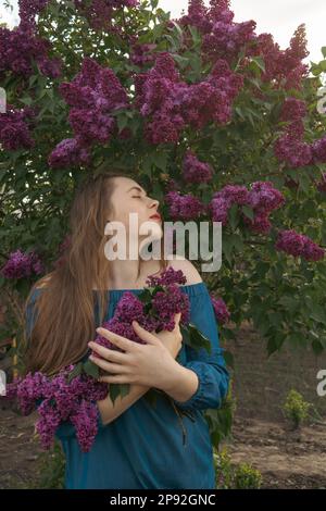 Bouquet of colorful lilac flowers in a wicker basket. Spring summer ...