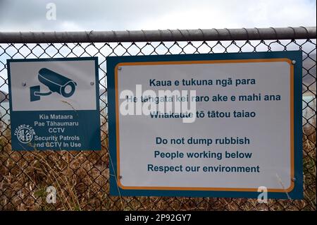 A bi-lingual sign at the overlook at Lyttelton Harbour coal processing ...