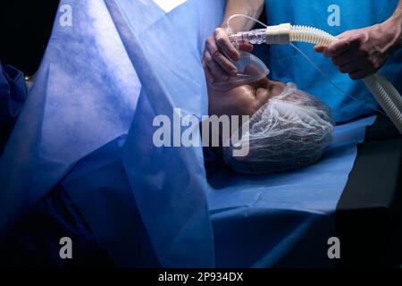 Man under anesthesia lies on the operating table Stock Photo - Alamy