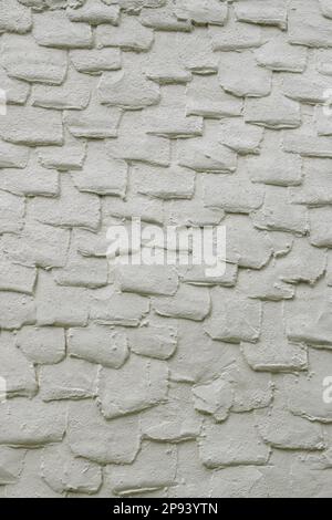 Concrete render creating a pattern on the wall of an old clay lump ...