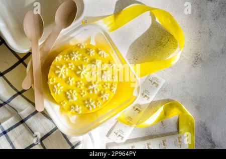 Trendy bento cake yellow color with cute decor on light background ...