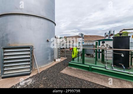 A fenced area containing tanks and piping for methane gas which is ...