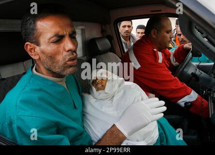 A Palestinian Red Crescent medic carries the body of Basma Al Jelawi, 5 ...