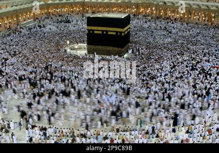 Tens of thousands of Muslim pilgrims move around the Kaaba, the black ...