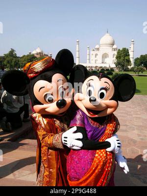Mickey Mouse and Minnie Mouse pose at the Taj Mahal in Agra, India. The ...