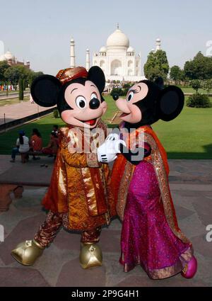 Mickey Mouse and Minnie Mouse pose at the Taj Mahal in Agra, India. The ...