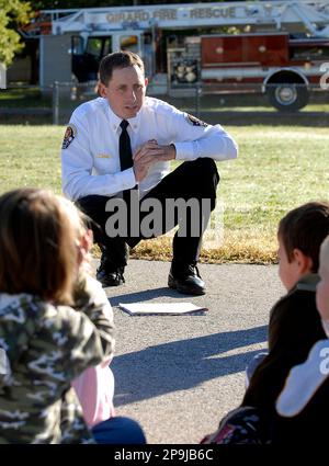 Assistant Fire Chief Dustin Johnson, left, describes what's happening ...