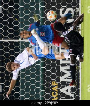 Cruz Azul goalkeeper Alfonso Blanco, background right, watches the ball ...