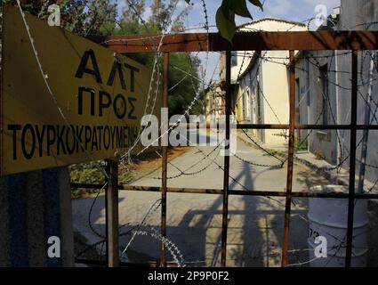 a sign reads "UN Buffer Zone, Keep Out" at a border crossing between ...