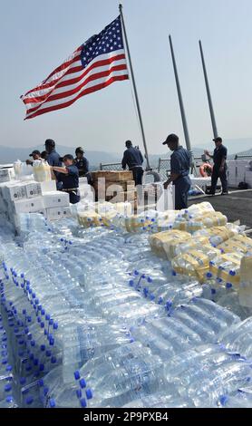 US Navy Sailors prepare to unload a combat rubber reconnaissance craft ...
