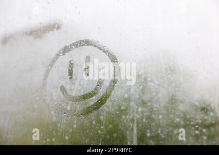 Funny face drawn on foggy window, space for text. Rainy weather Stock ...