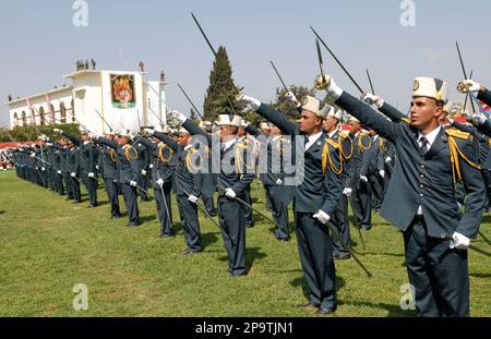 Lebanese officers raise their swords during a graduation ceremony ...