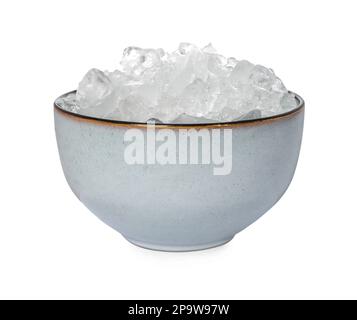 Glass bowl with a pile of ice cubes backlit on a reflective base with ...