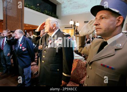French Army Reserve Col. Mathieu Petitjean, wears white gloves as he ...