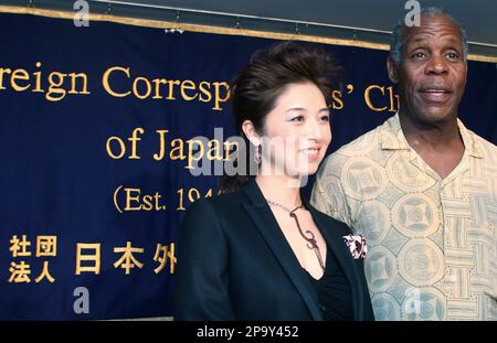 Hollywood star Danny Glover, right, smiles with Japanese actress Saki ...