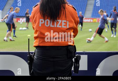 Female Swiss police officer in uniform with equipment, from behind ...