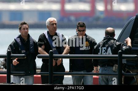 Suspected Syrian arms dealer Monzer al-Kassar, center, is escorted from ...