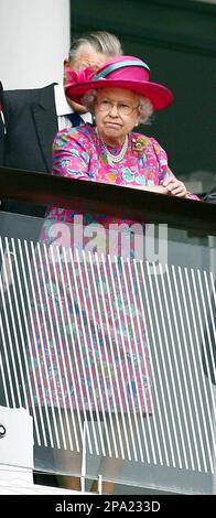 Queen Elizabeth II looks out of the window of Buckingham Palace, in ...