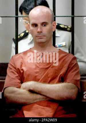 Canadian Christopher Paul Neil sits in the cell at criminal court in ...