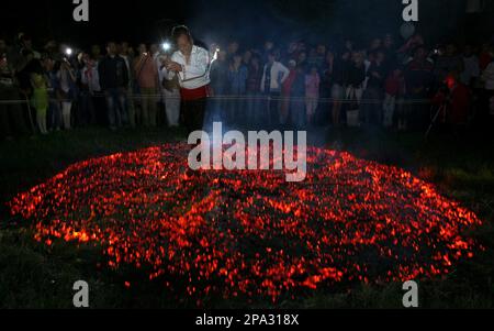Bulgarian Nestinari dancer performs barefoot over smoldering embers as ...
